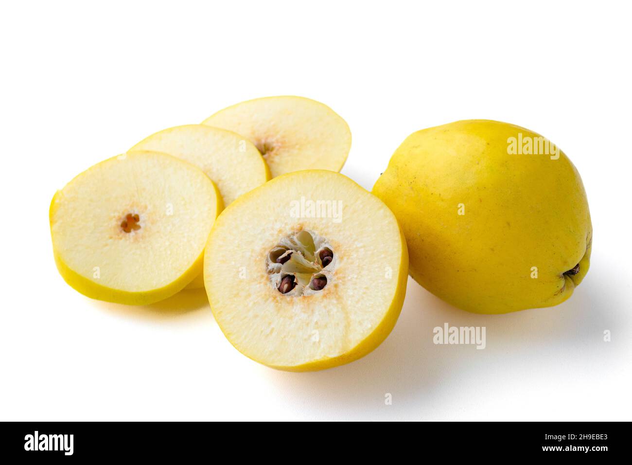 Fresh quince fruits with half and slices isolated on a white background ...