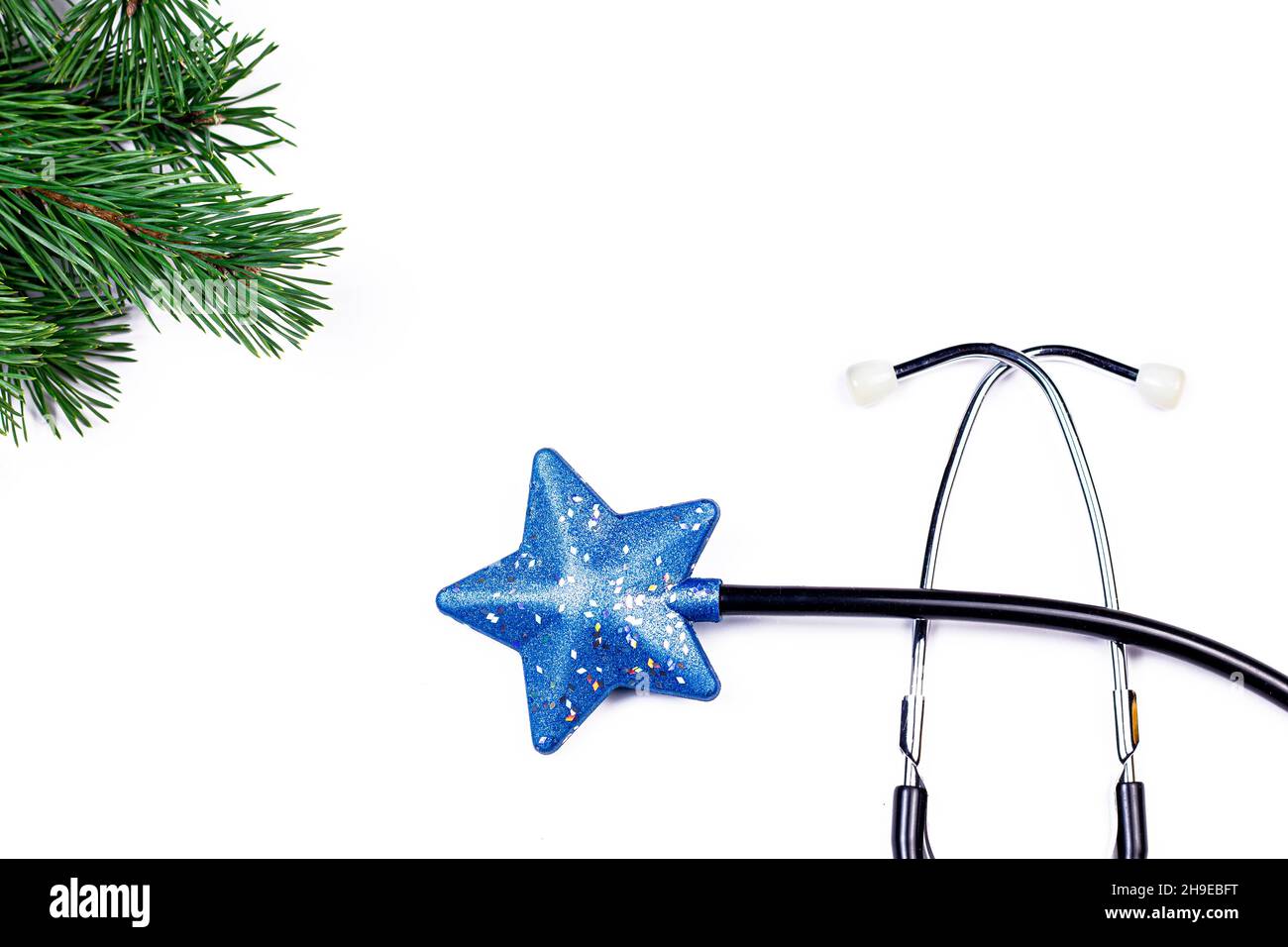 Medical Stethoscope with Christmas star toy and fit tree branch on ...