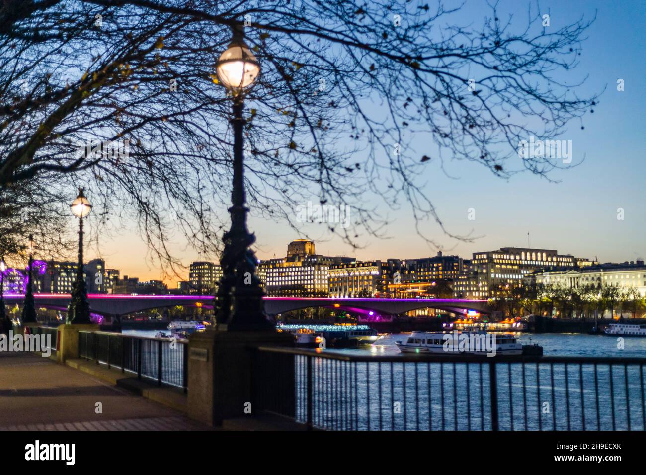 Southbank riverside and view of London Bridge lit at night, London ...
