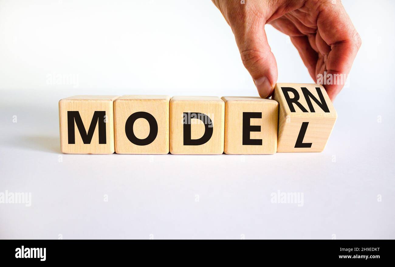 Modern model symbol. Businessman turns a wooden cube and changes the ...