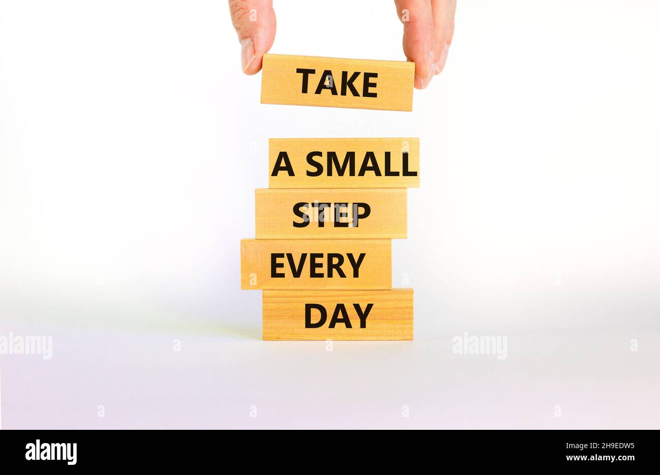 Take a small step every day symbol. Wooden blocks with words Take a ...
