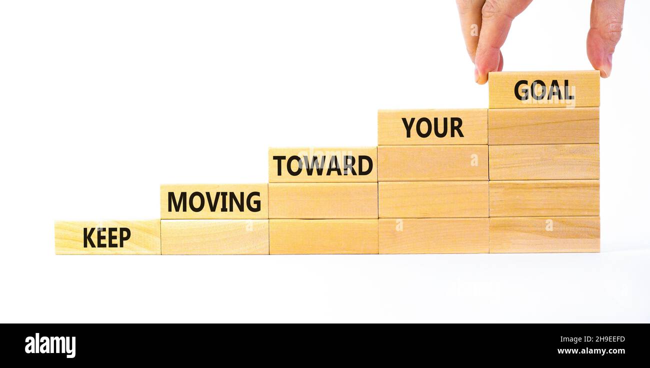 Keep moving toward your goal symbol. Wooden blocks with words Keep ...