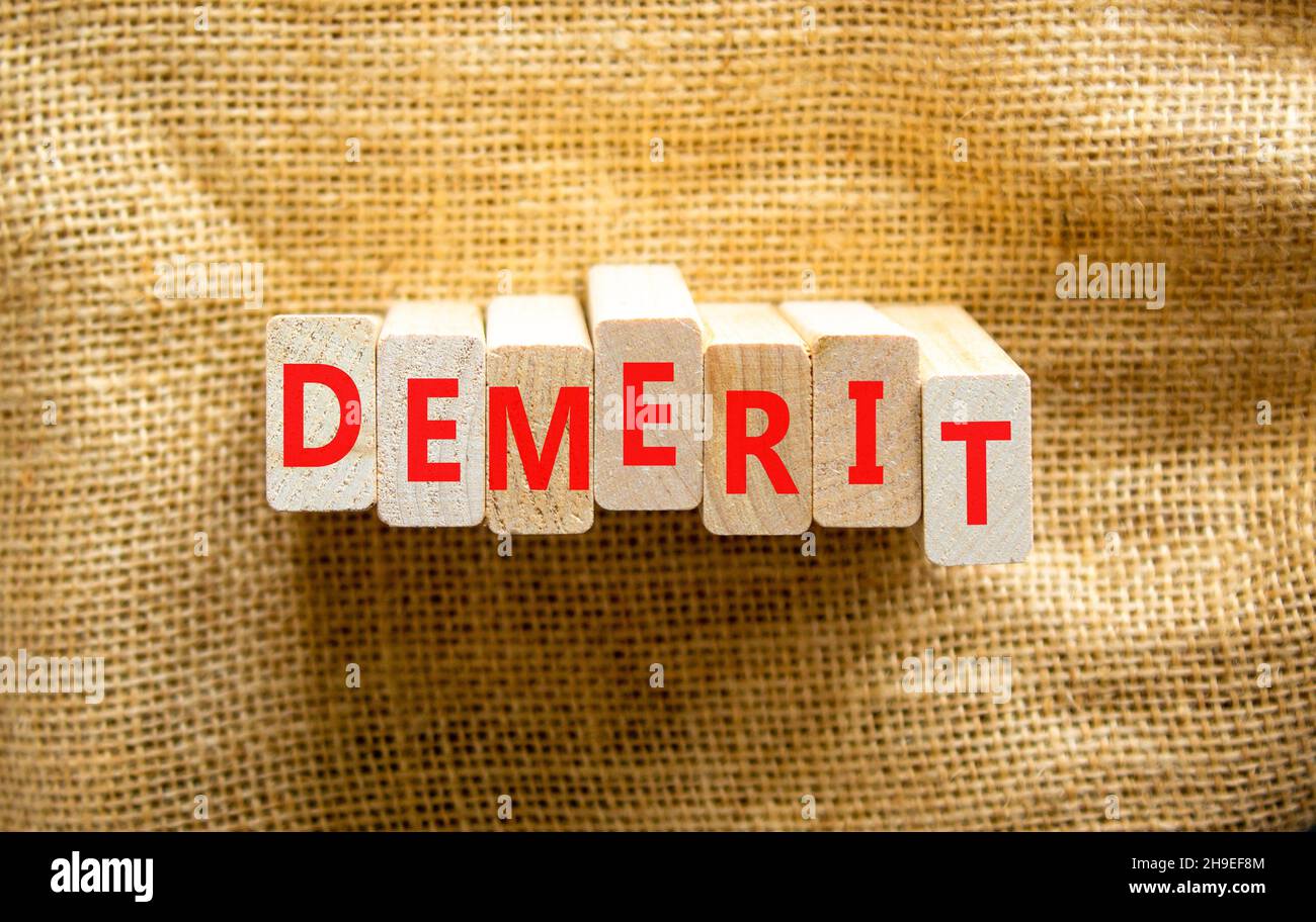 Demerit symbol. The concept word Demerit on wooden blocks. Beautiful ...