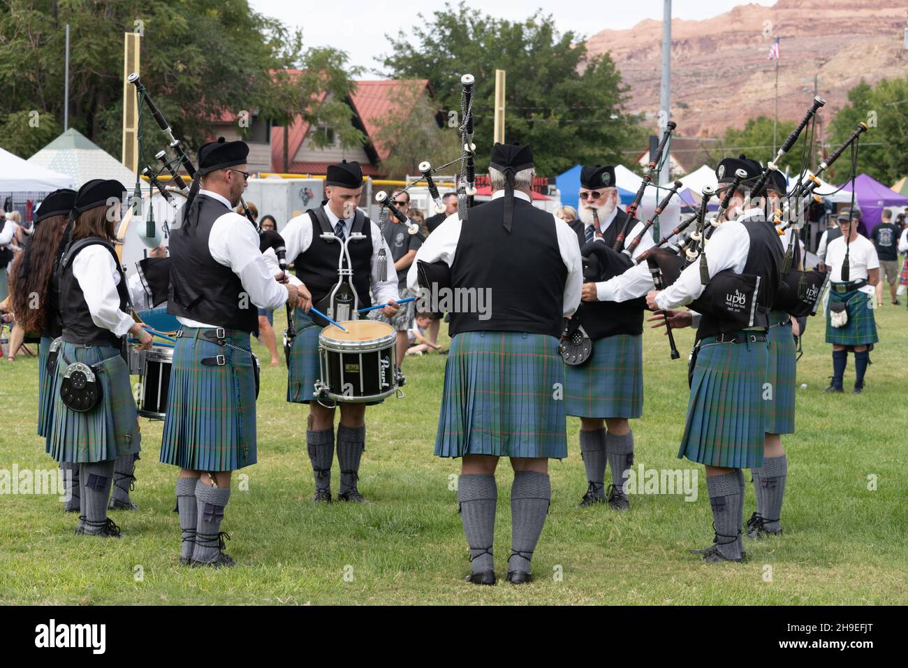 A Highland pipe band playing Great Highland bagpipes and drums in a ...