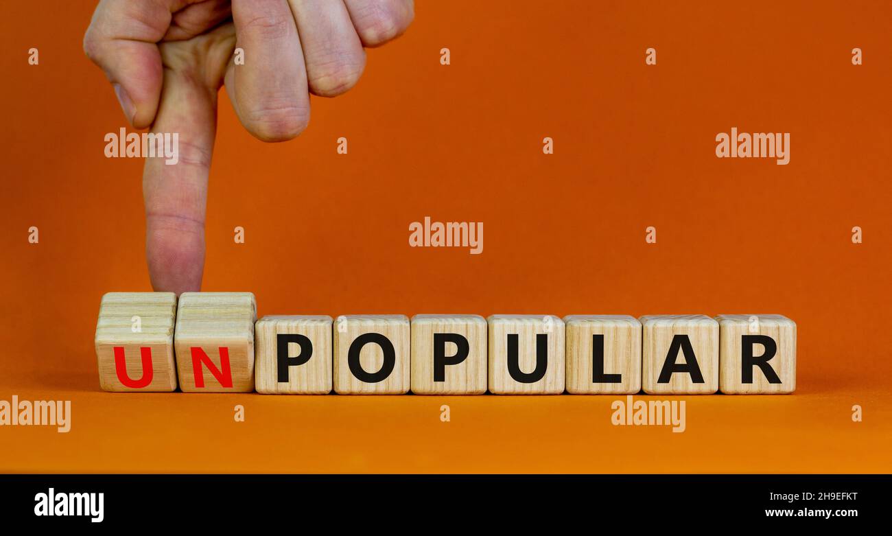 Popular or unpopular symbol. Businessman turns wooden cubes and changes ...