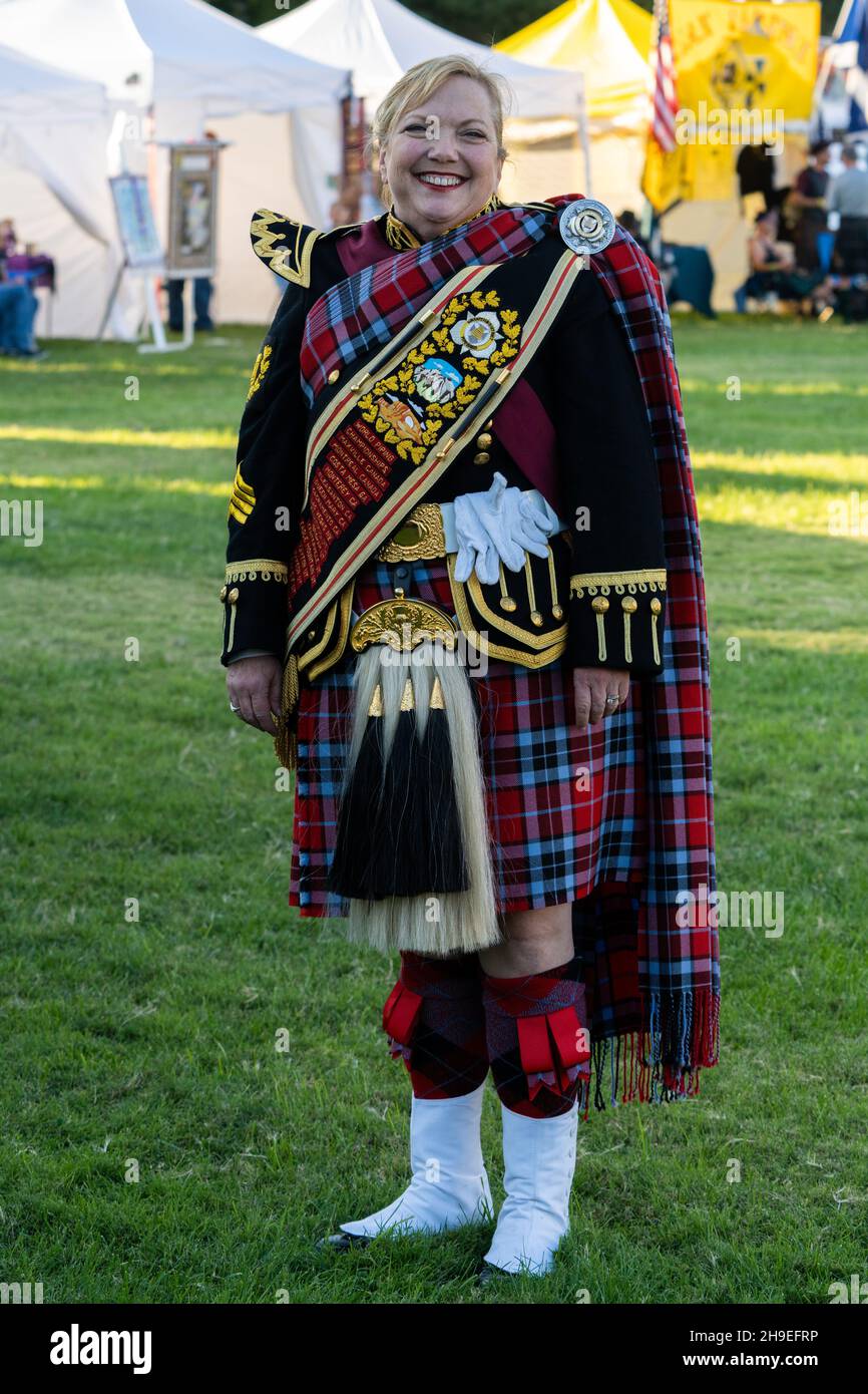 A HIghland pipe band drum major in her full regalia at a Scottish ...