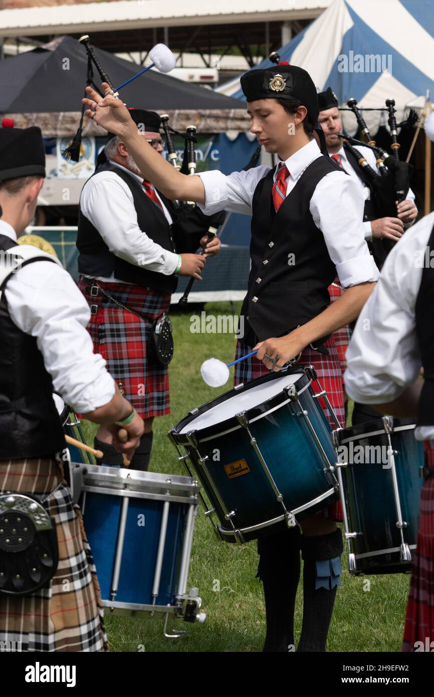 A drummer in a Highland Scottish pipe band flourishes or twirls his ...