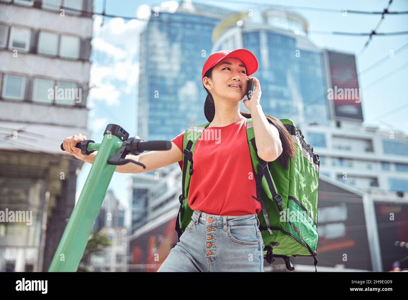 Asian female delivering takeaway food to customer outdoors Stock Photo ...