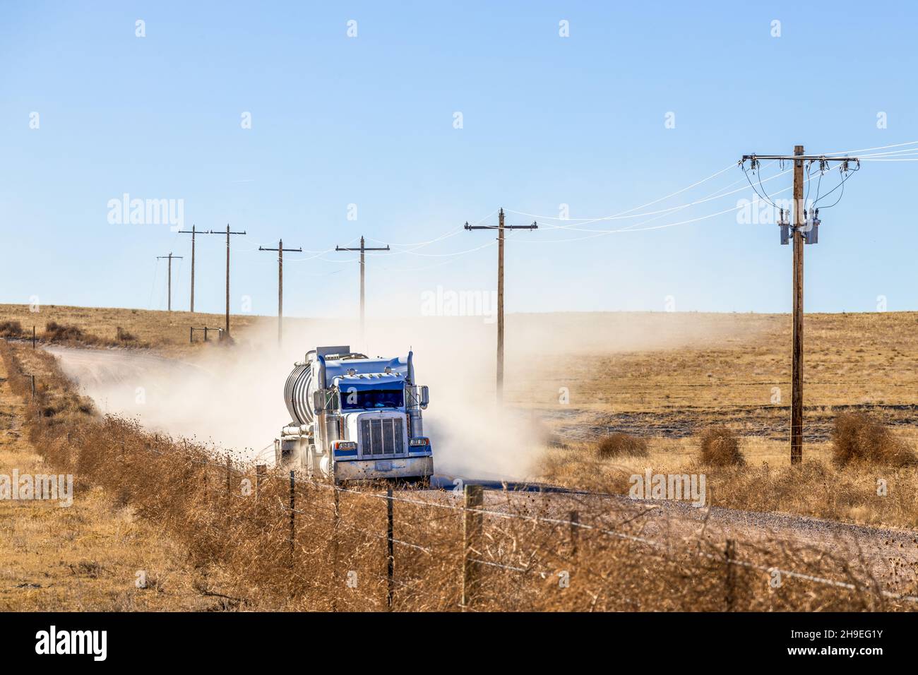 Dust raised by a heavy truck on a dirt road in Northeastern Colorado ...