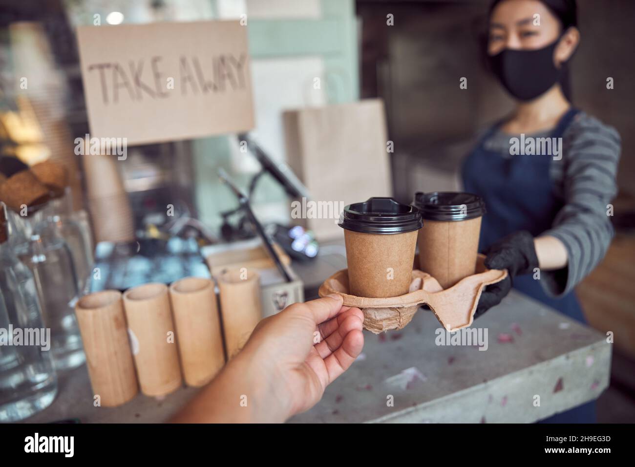 Female worker giving customer delicious coffee in modern cafe Stock ...