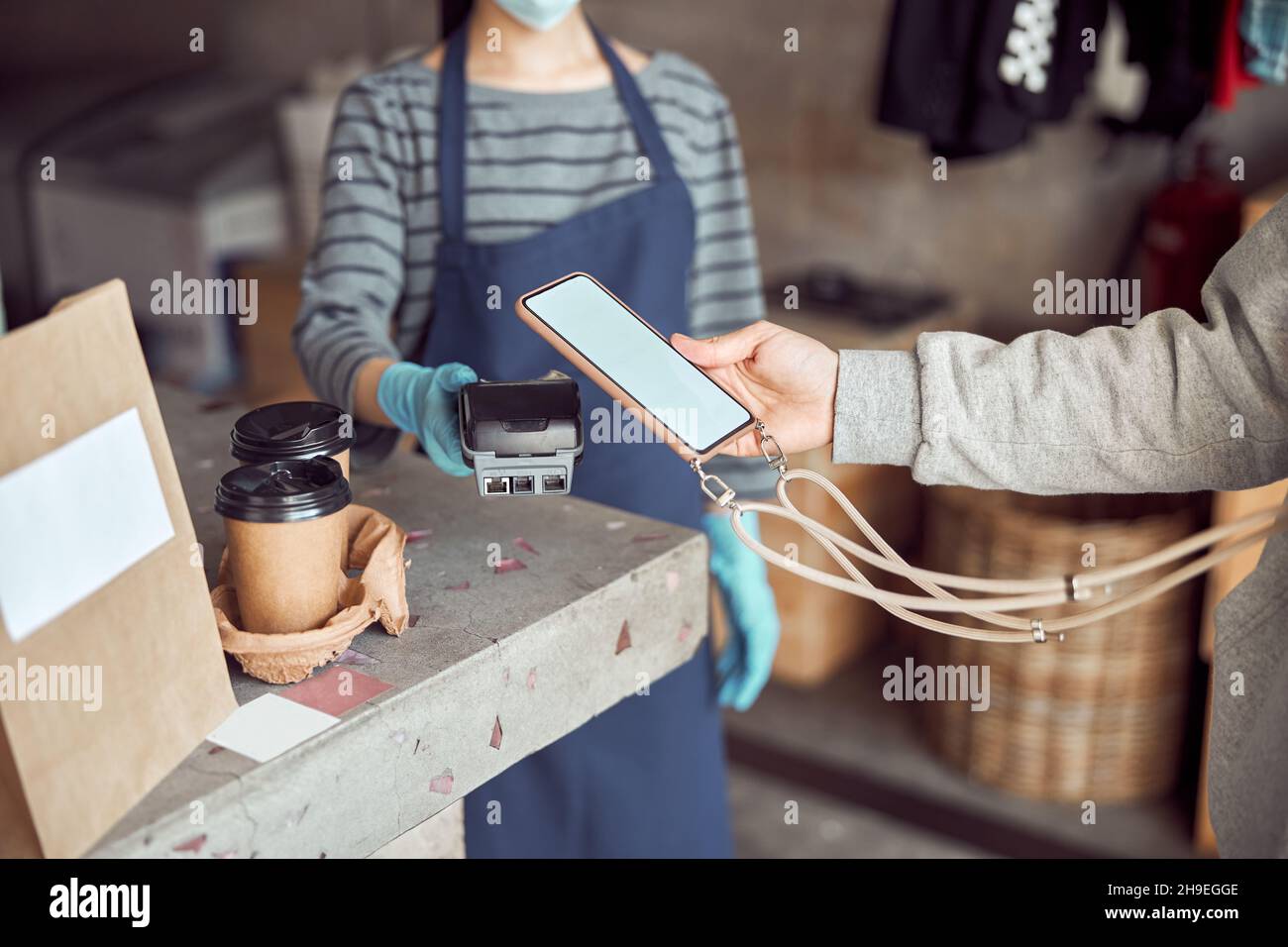 Customer pay with cellphone on pos terminal Stock Photo - Alamy