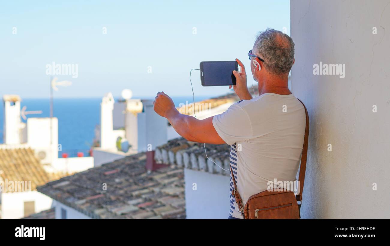 Handsome caucasian man taking pictures in the city on a sunny day Stock ...