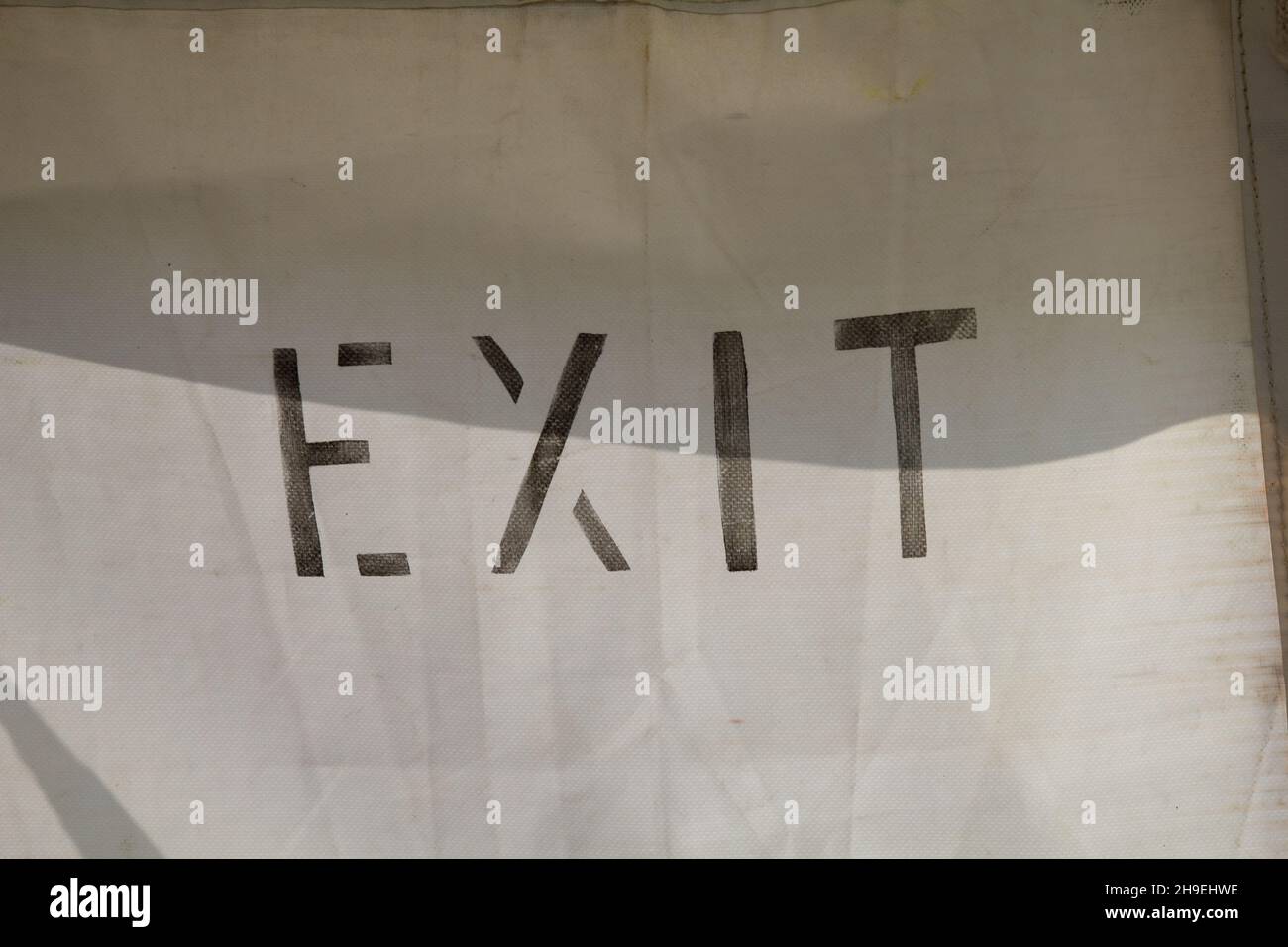 Exit sign or text printed on a canvas tent or marquee Stock Photo - Alamy