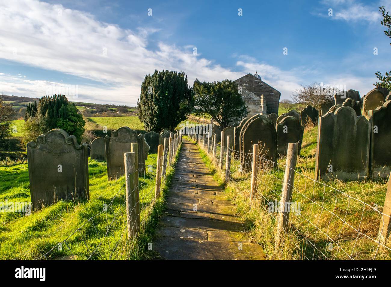 Trail with fence next to ancient gravestones in Yorkshire England Stock ...