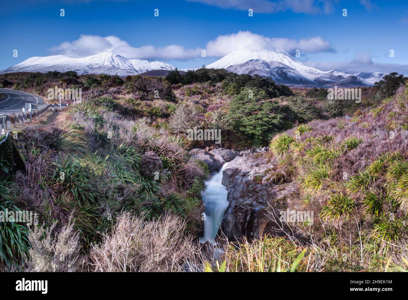 The remote Mahuia Rapids below the snow capped volcanic mountains in ...