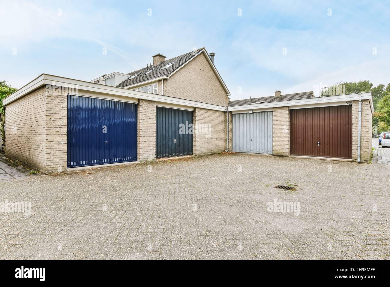 Lovely street with garages with colorful gates Stock Photo - Alamy