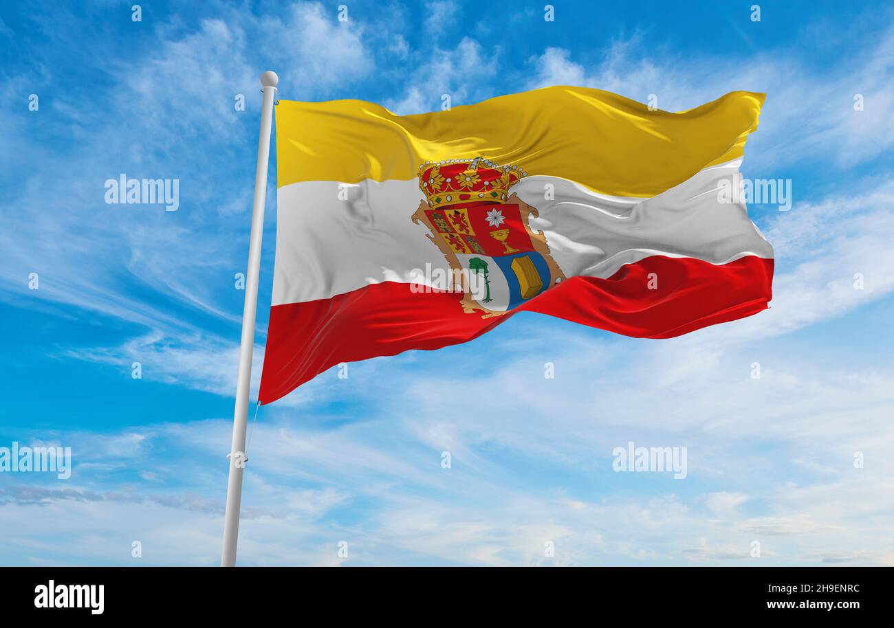 flag of Cuenca Province , Spain at cloudy sky background on sunset ...