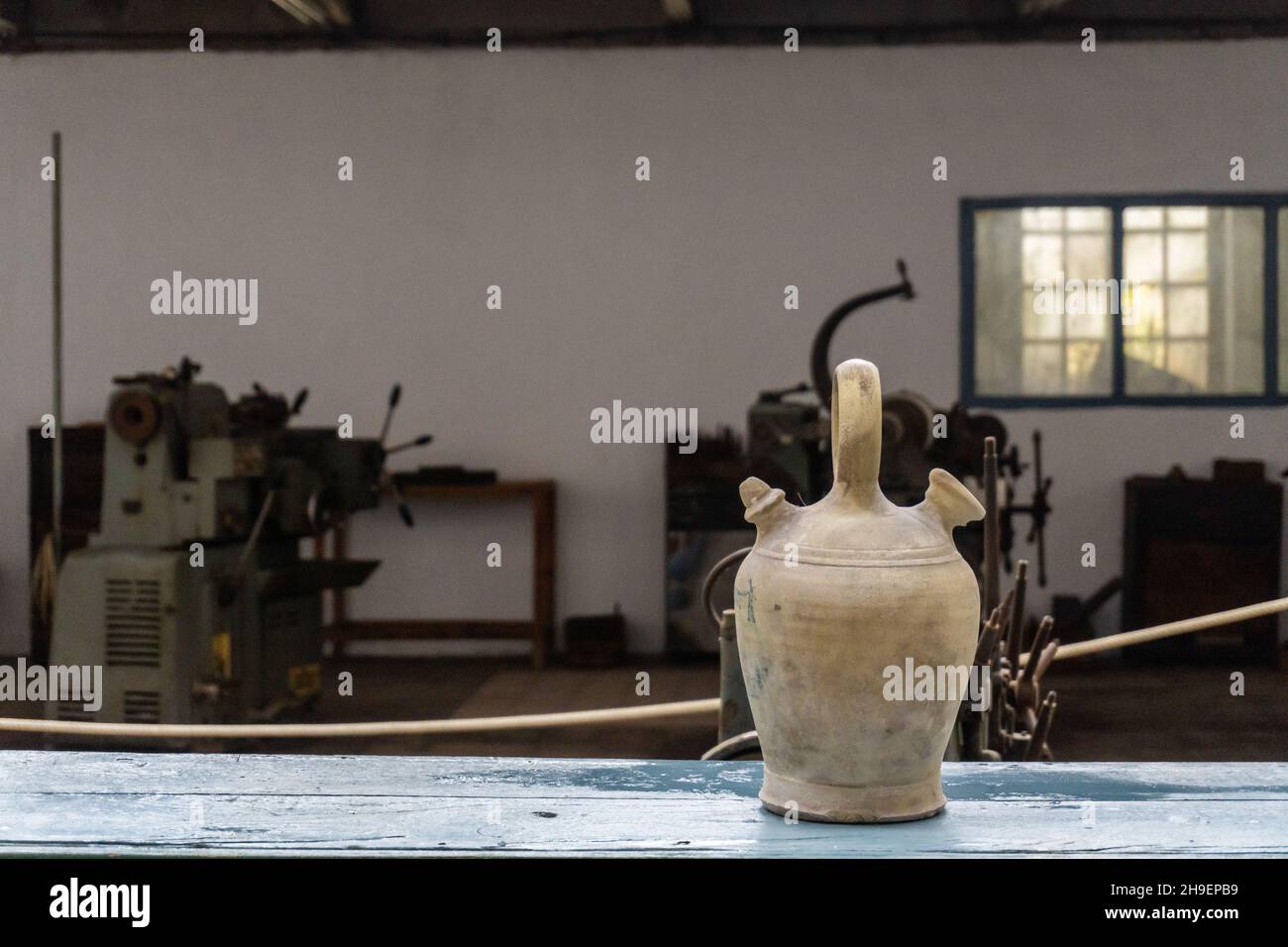 Closeup shot of traditional Spanish Botijo clay jug displayed in the ...