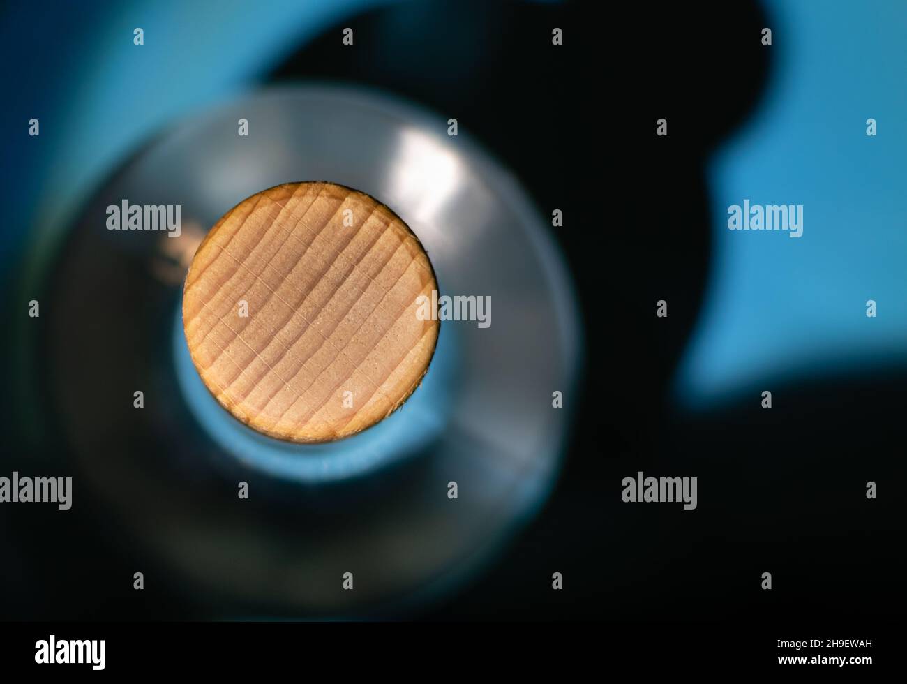 Bottle cork close-up from above on blurred blue background with shadows ...