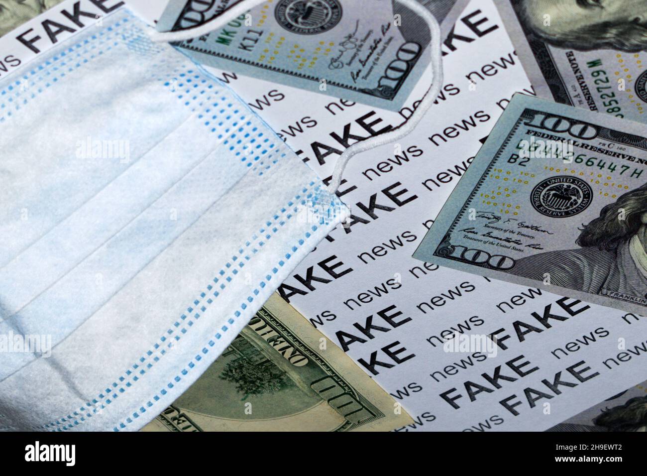 Disposable face anti virus mask and dollars on fake news text ...
