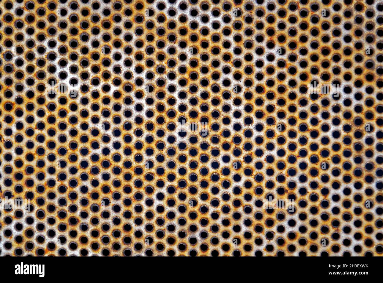 Perforated metallic surface texture background Stock Photo - Alamy