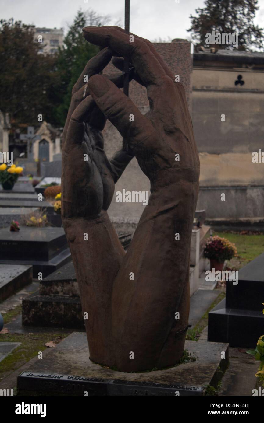 This pair of giant hands emerging from the ground Montparnasse Cemetery ...