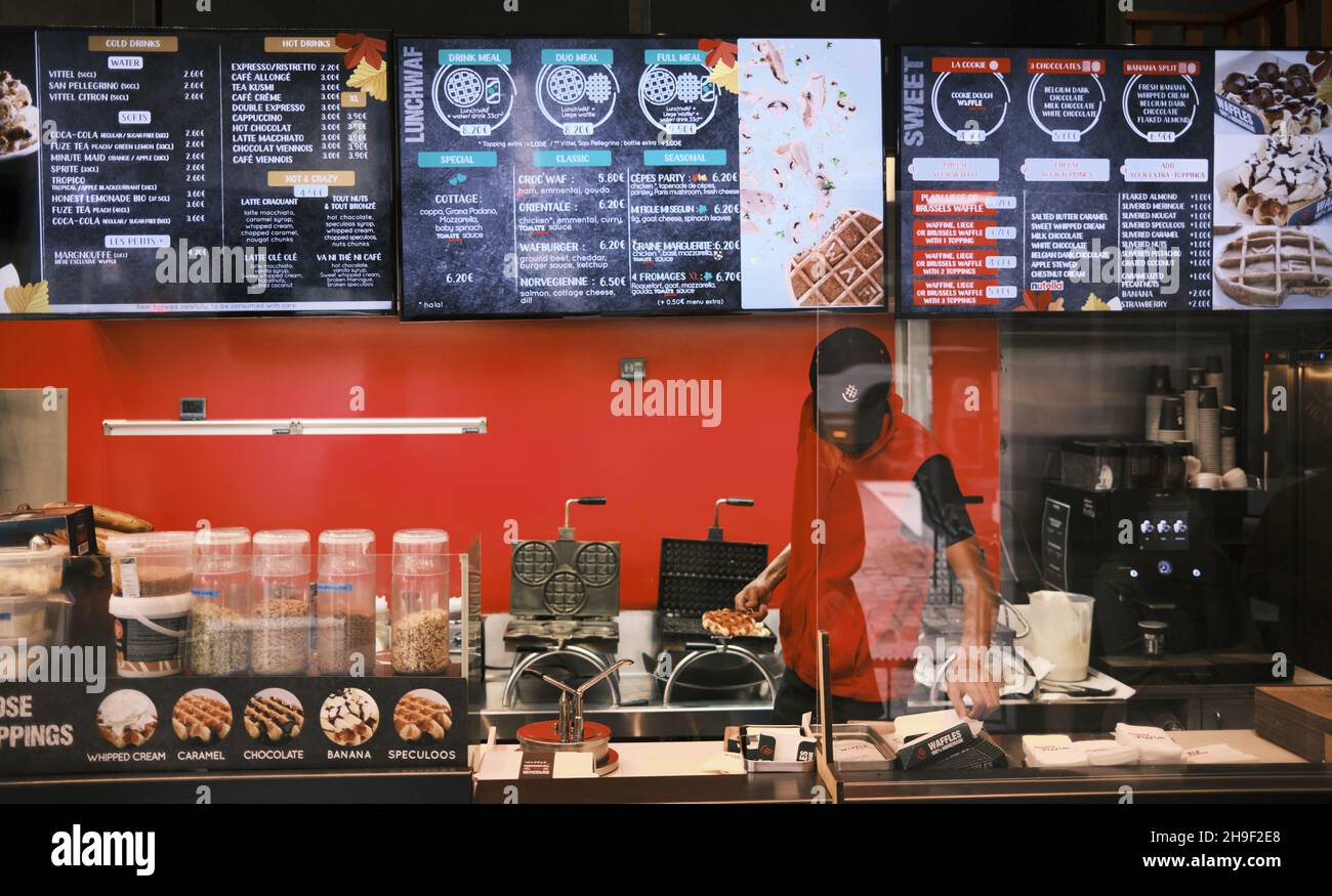 BRUSSELS, BELGIUM - Oct 26, 2021: An employee making waffles at the ...