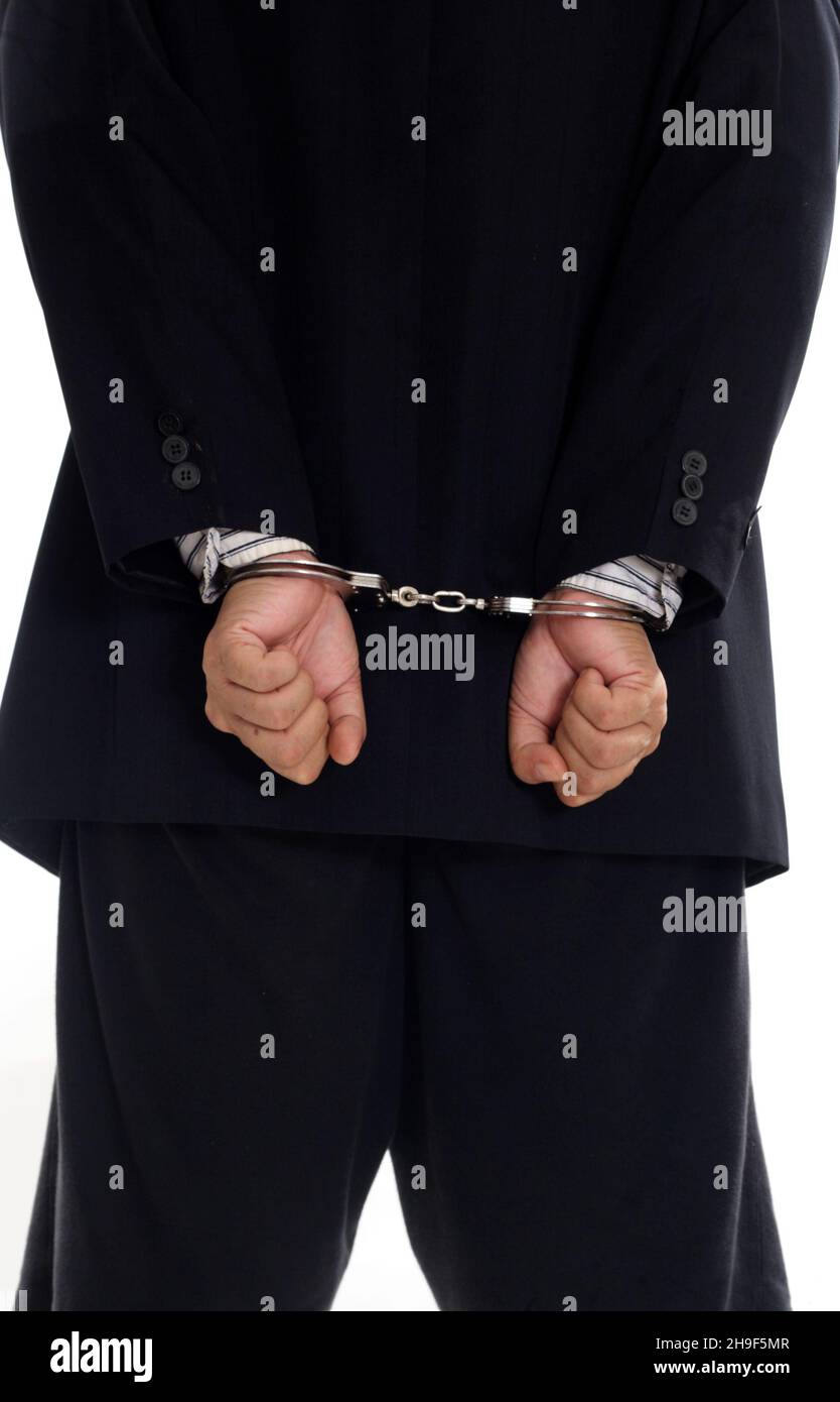 Man in handcuffs, isolated on white Stock Photo - Alamy