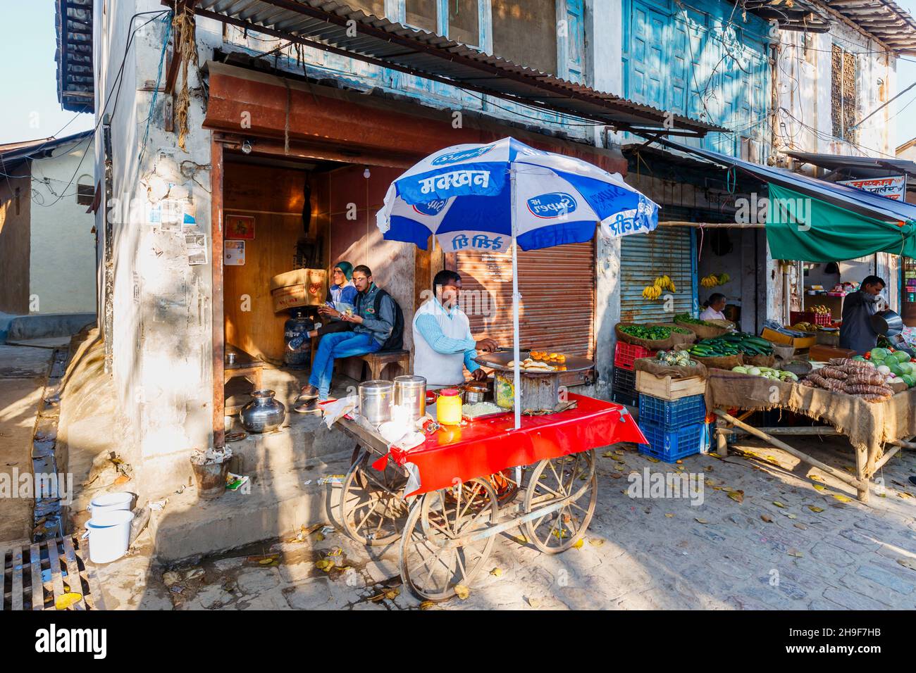 Street food being cooked by a local seller on a roadside barrow in ...