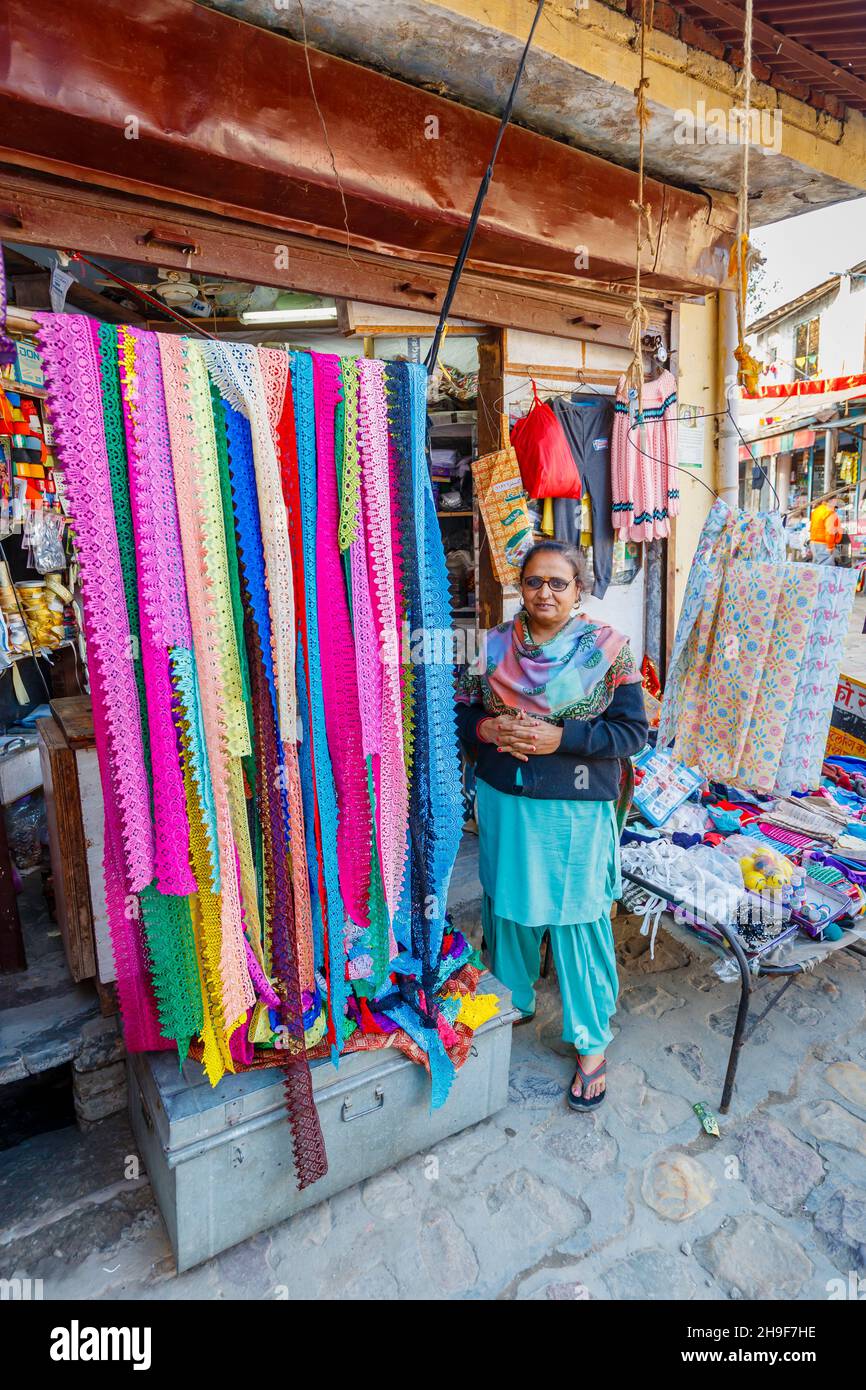 A local elderly female shopkeeper tends a fabric shop in Pragpur, a ...