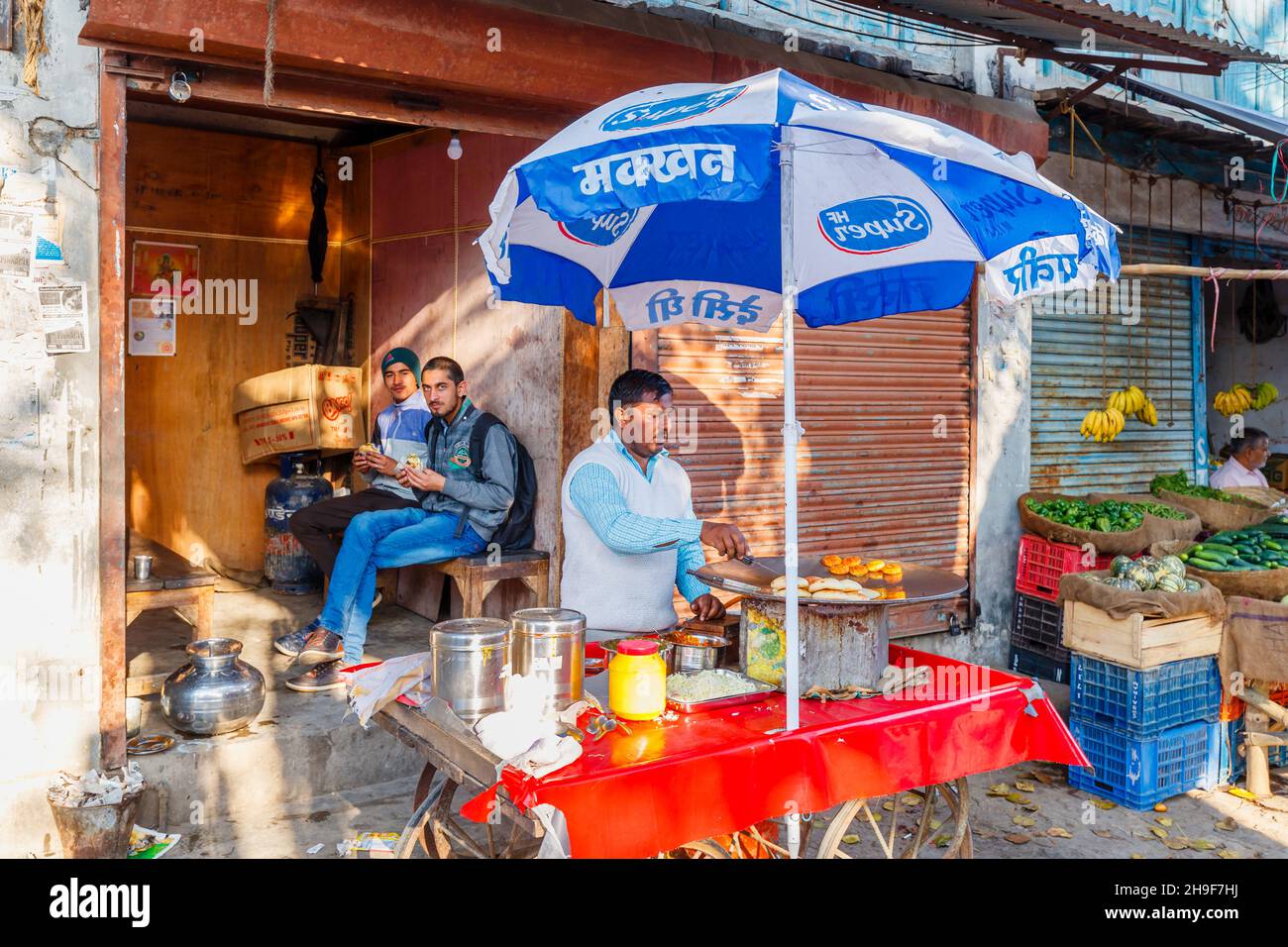 Street food being cooked by a local seller on a roadside barrow in ...