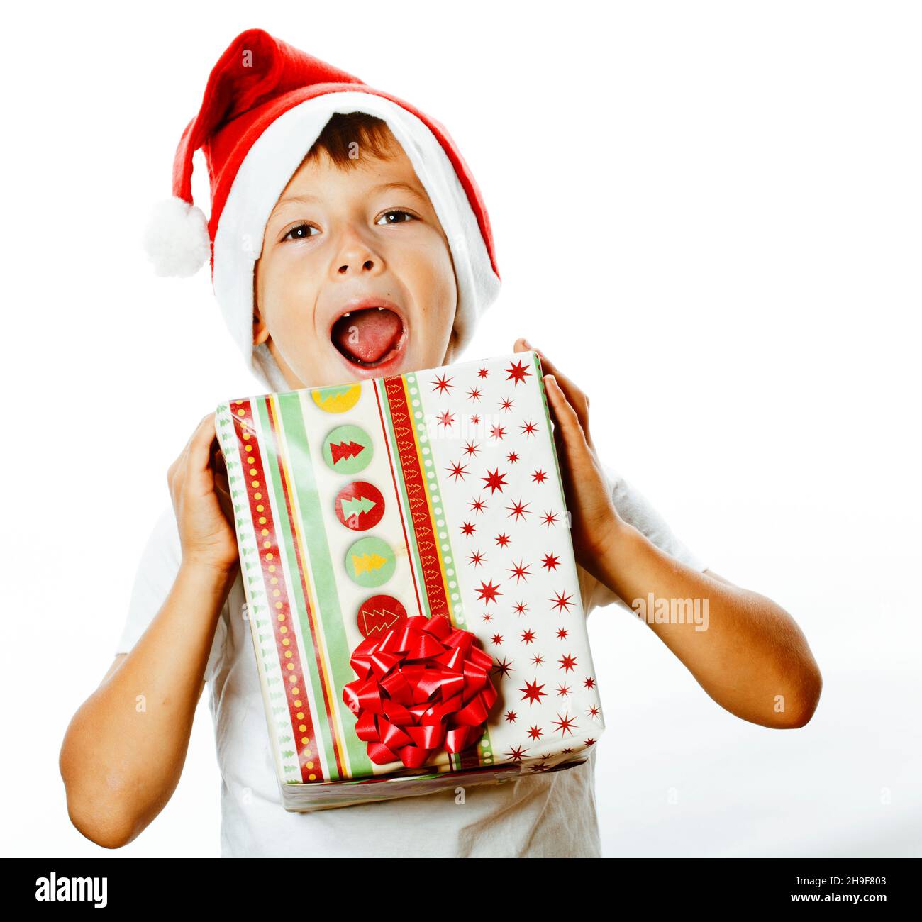 young pretty boy in santas red hat isolated on white background holding ...