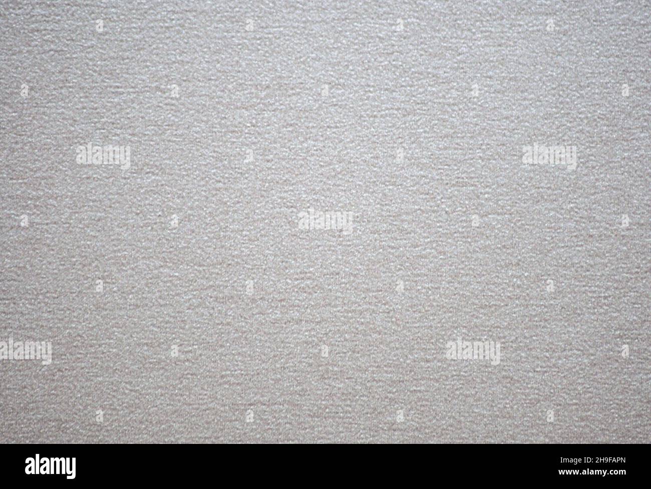 A polished surface of a silvery metal, with a chipped surface ...