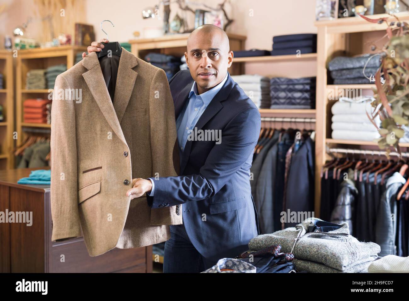 Positive young salesman demonstrating hi-res stock photography and ...