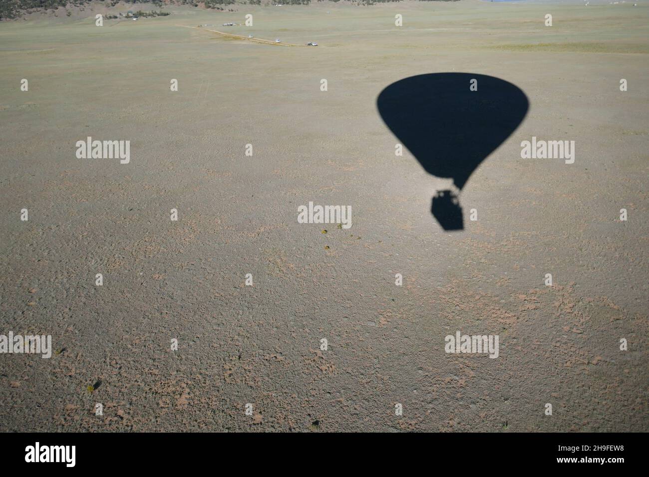 Hot air balloon shadow on ground viewed as balloon passenger Stock ...