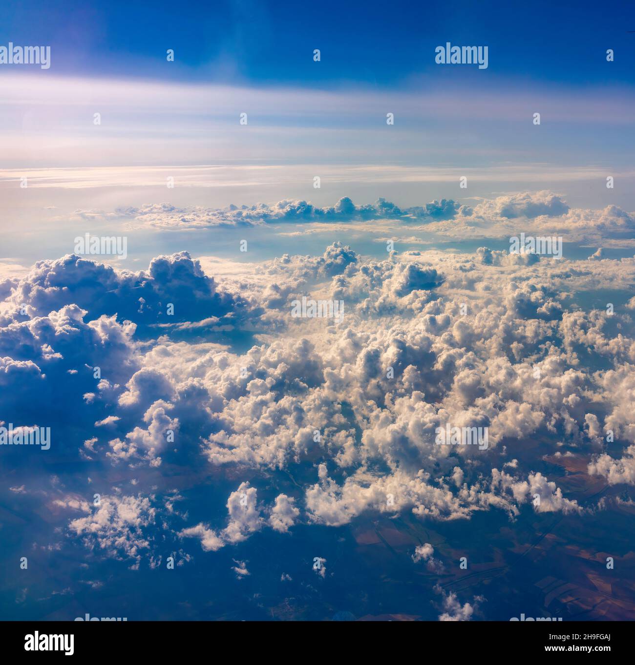 Aerial view from airplane window above green ground. View from the ...