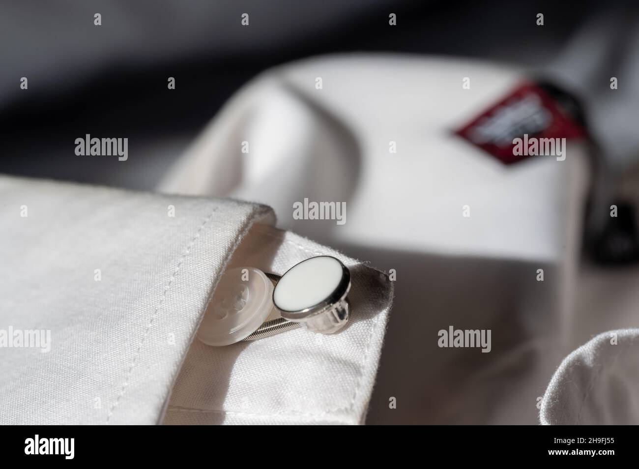 button extender shown on a white dress shirt to increase size Stock ...