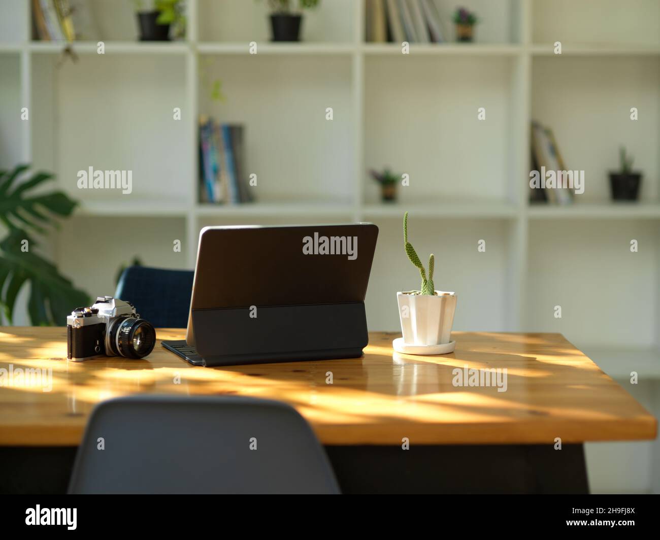 Simple working desk with digital tablet computer and camera in brighten ...