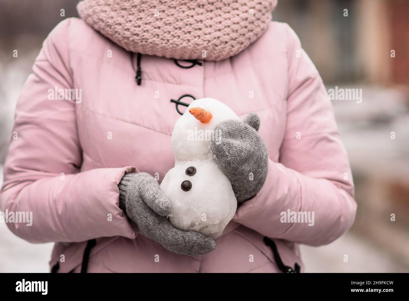 a small snowman made of snow in the hands Stock Photo - Alamy