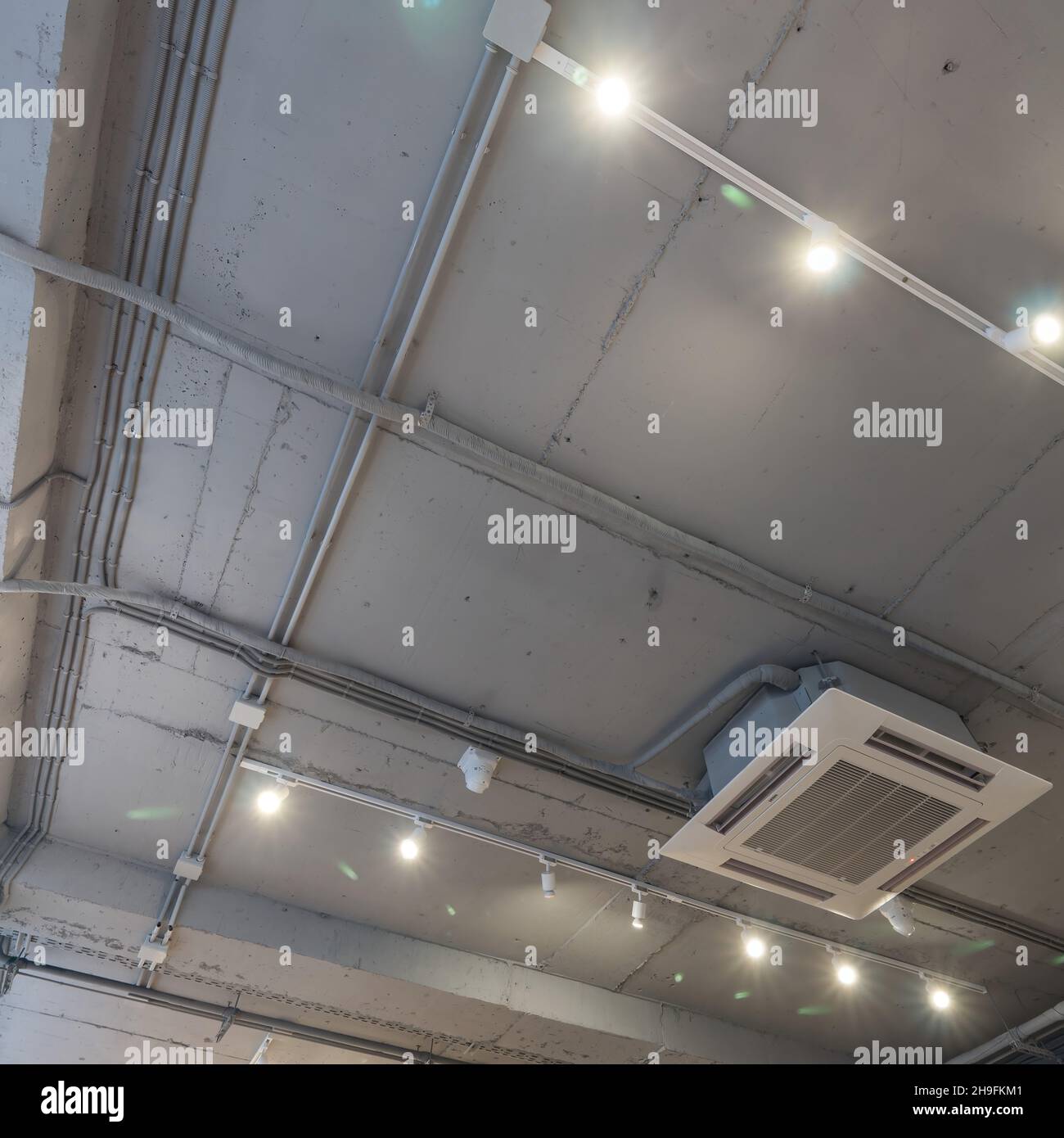 Abstract loft interior of concrete grey ceiling with air ventilation ...
