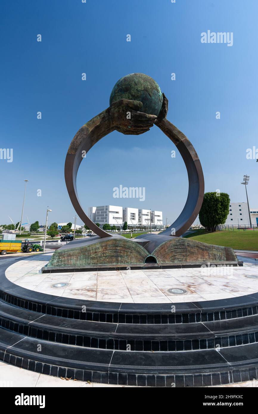 QATAR - NOV 13, 2021:A sculpture of hands rising from a book support ...