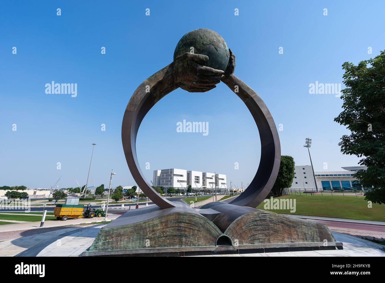 QATAR - NOV 13, 2021:A sculpture of hands rising from a book support ...