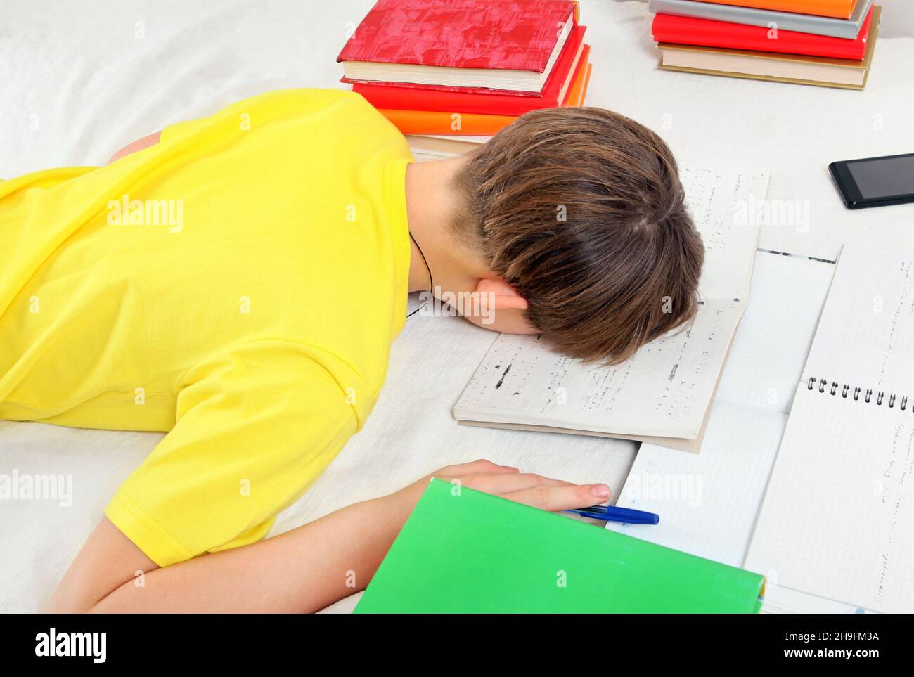 Sad and Tired Teenager doing Homework at the Home Stock Photo - Alamy