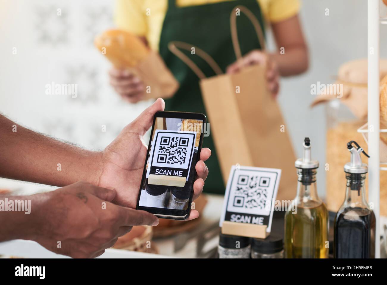 Hands of man scanning QR code with smartphone to get bonuses when ...
