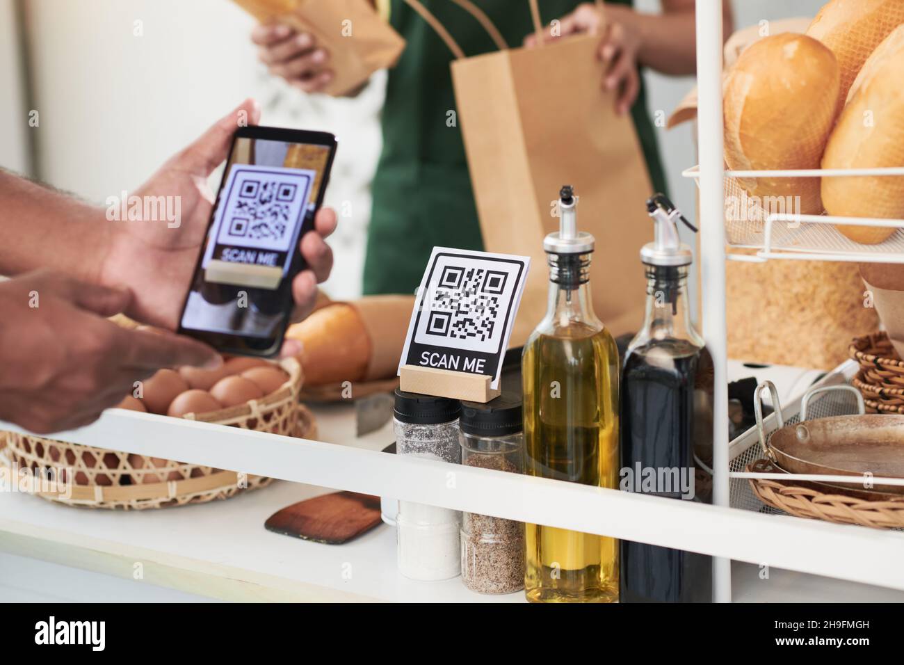 Customer scanning qr code with smartphone when receiving pick up order ...