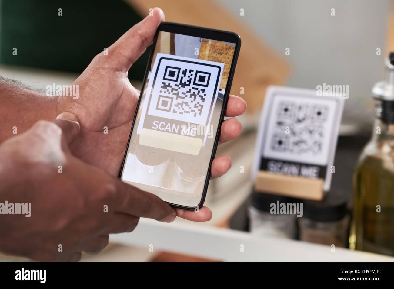 Close-up image of customer scanning QR code with smartphone to download ...