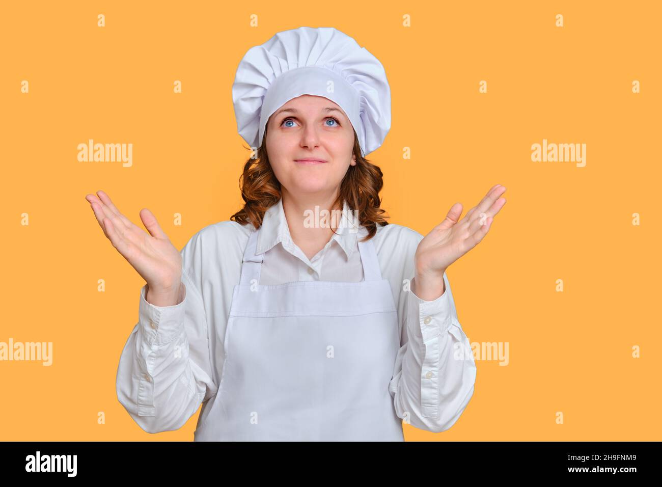 An ecstatic woman chef with a happy smile on her face on a studio ...