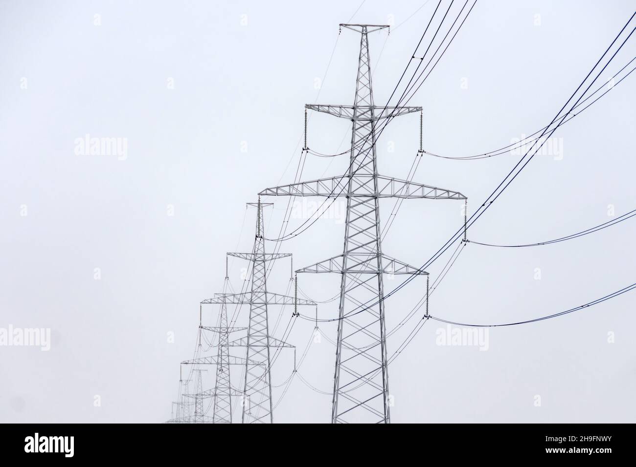 High-voltage wires extending into the distance line Stock Photo - Alamy
