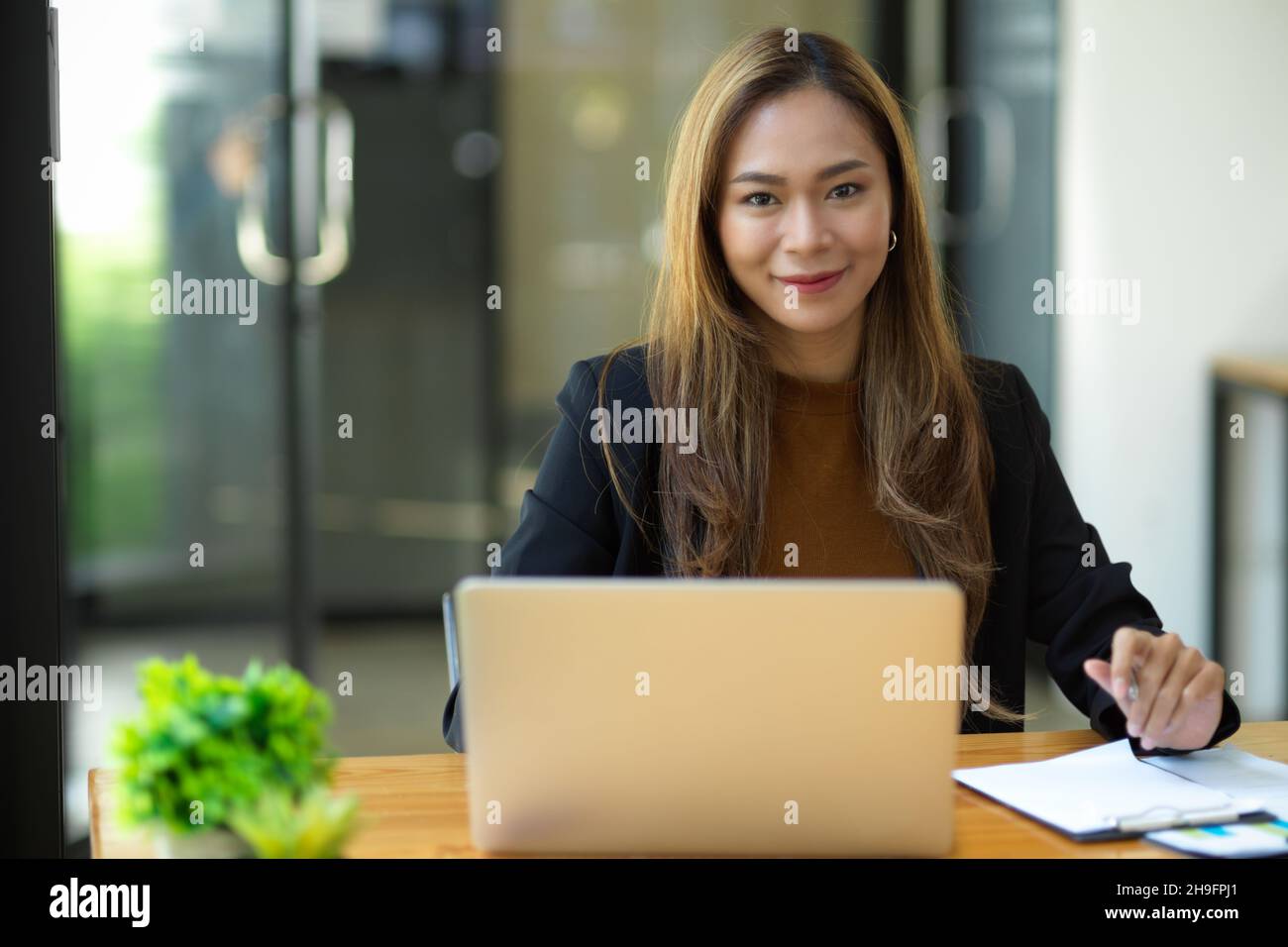 Portrait image of Happy business woman smile to camera while sitting at ...