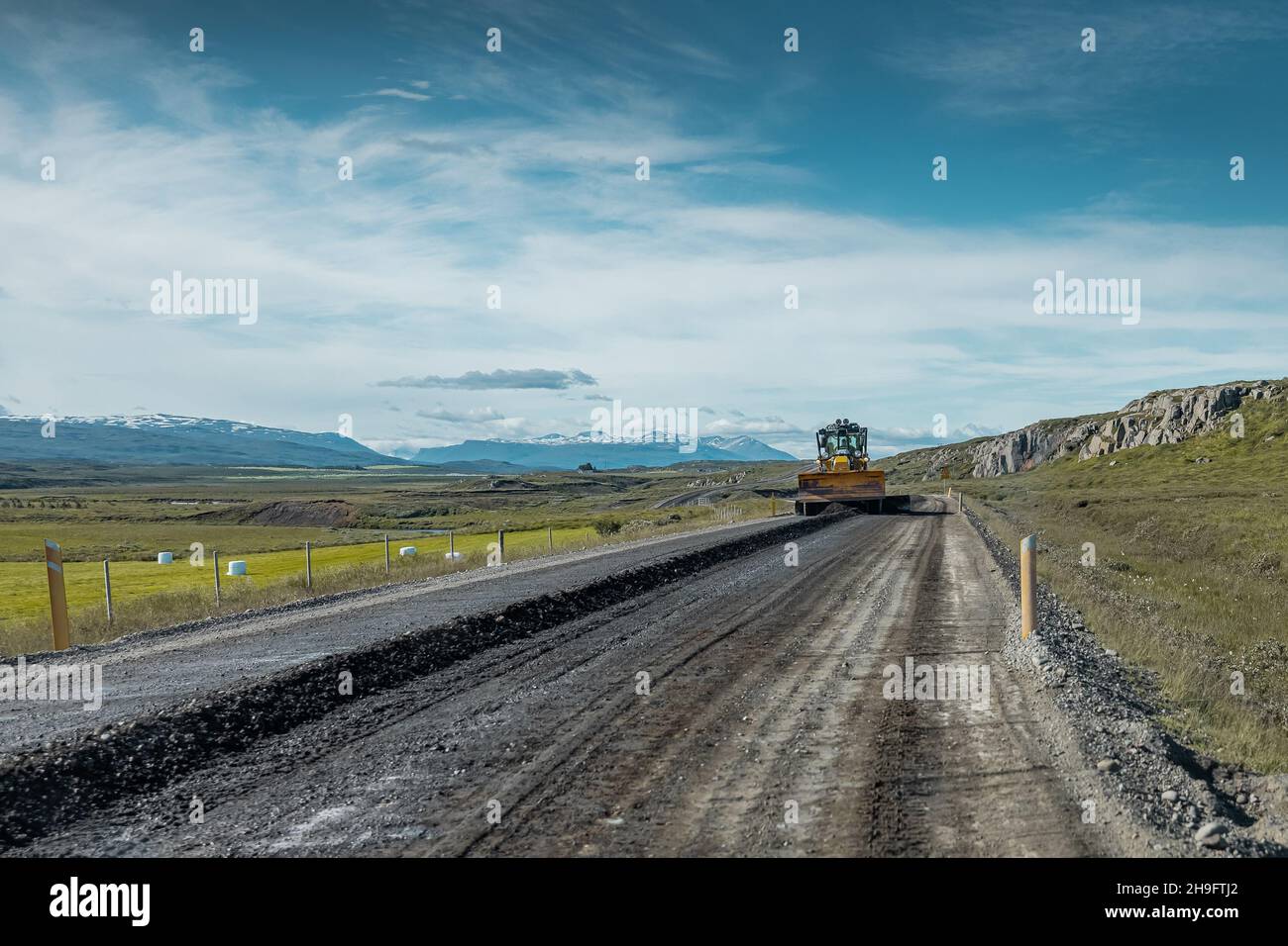 Grader grading or profiling gravel roads on Iceland. Routine ...